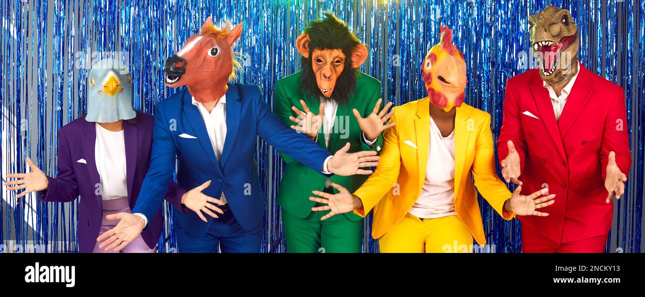 Group of men and women in colorful suits and funny animal masks having ...