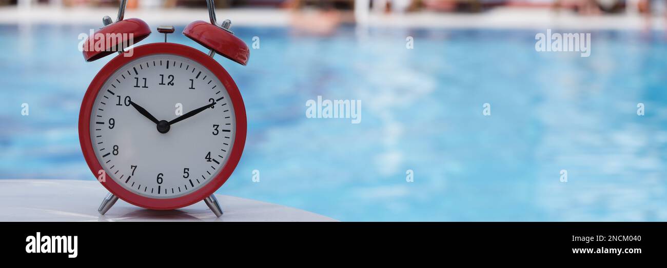 Red alarm clock for ten o'clock near pool in hotel or spa center Stock ...