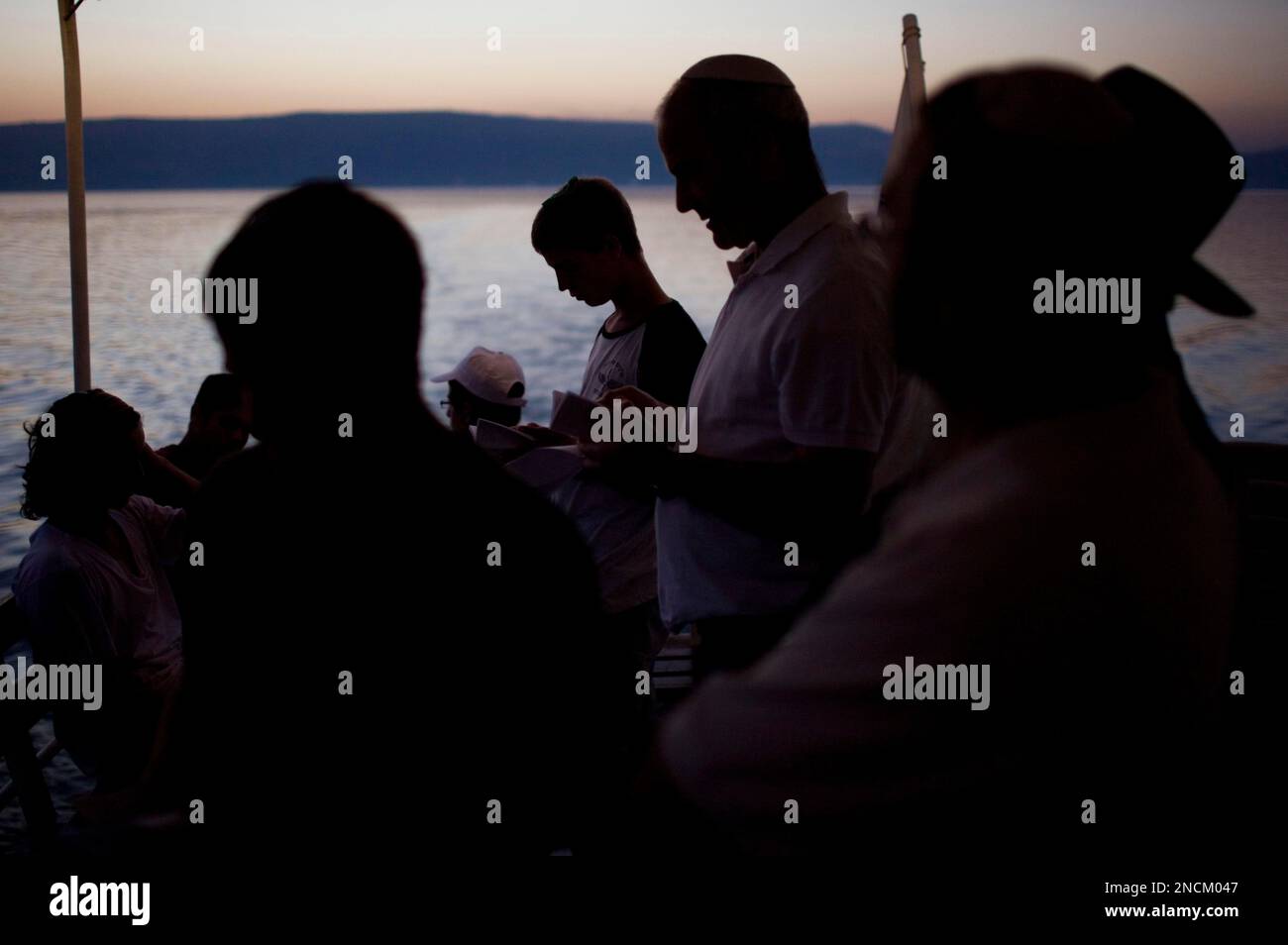 Jewish men take part in a special prayer for rain, on a boat in the Sea ...
