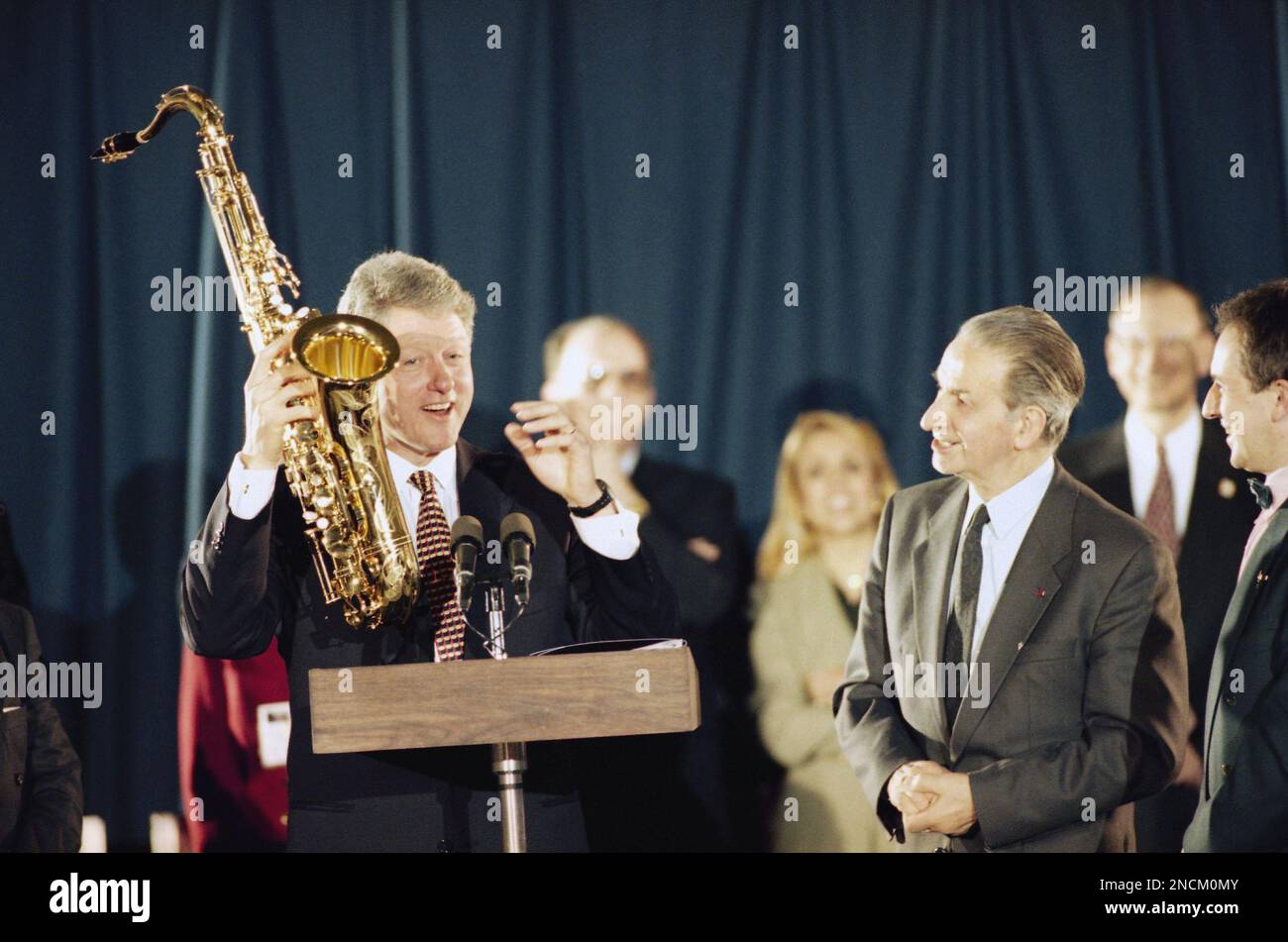 U.S. President Bill Clinton holds up a saxophone presented to him by ...