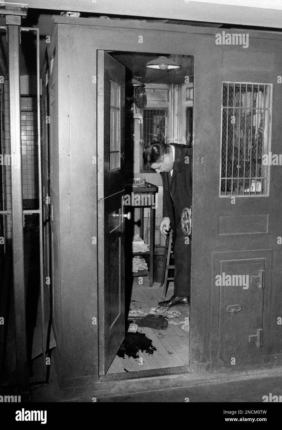 A New York City policeman examines the floor of a change booth at the ...