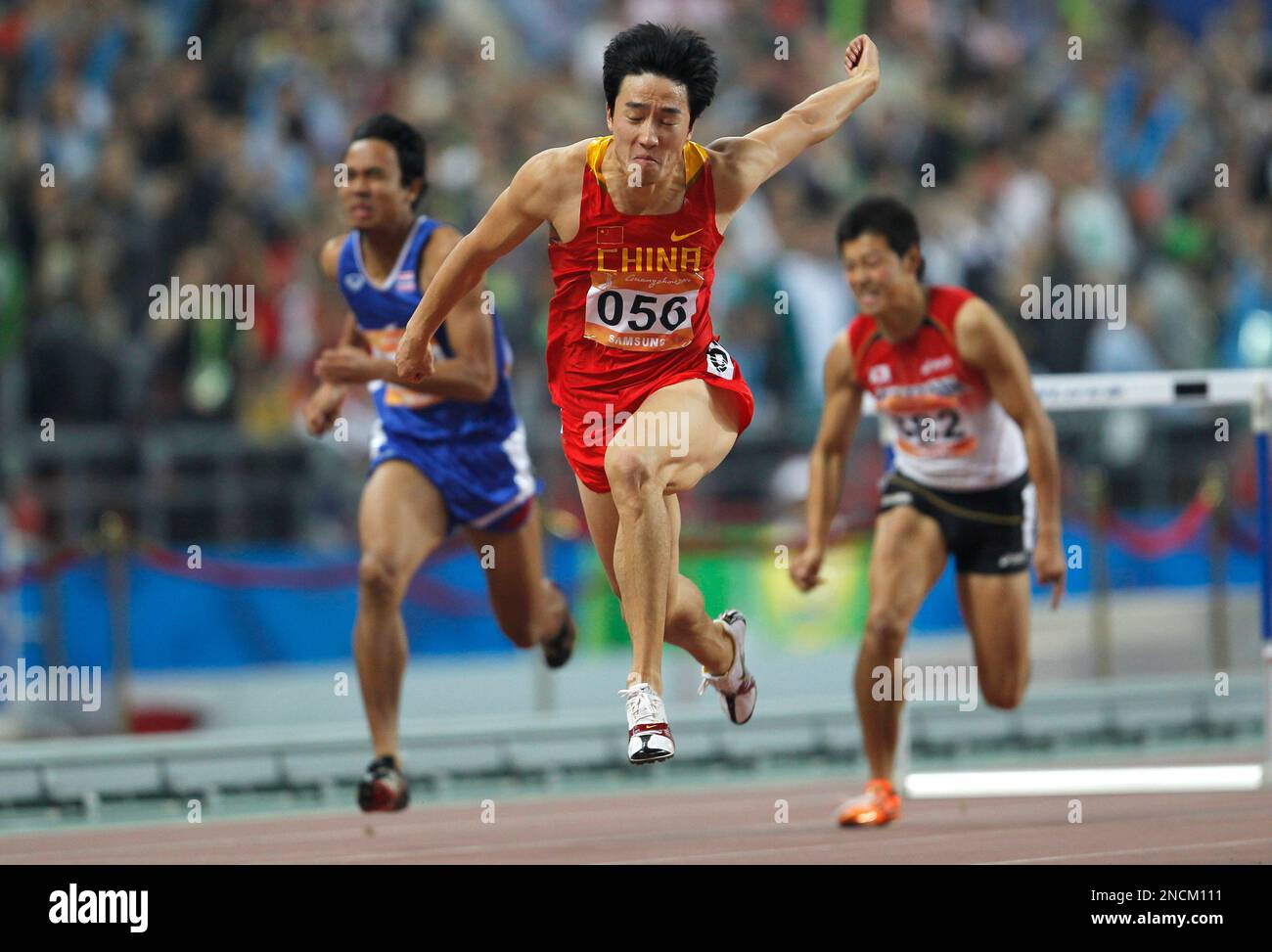 China's Liu Xiang crosses the finish line to win the gold medal in the ...
