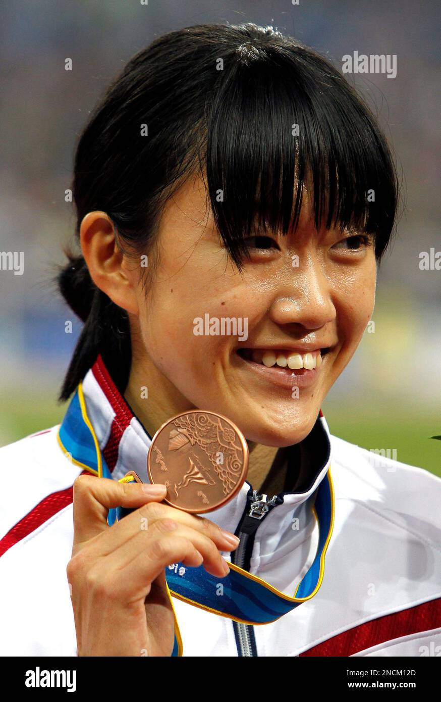 Japan's Tomomi Abiko shows the bronze medal she won in the women's pole ...