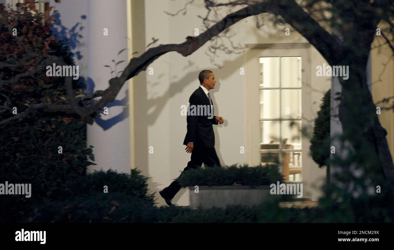 President Barack Obama walks back to the Oval Office at the White House ...