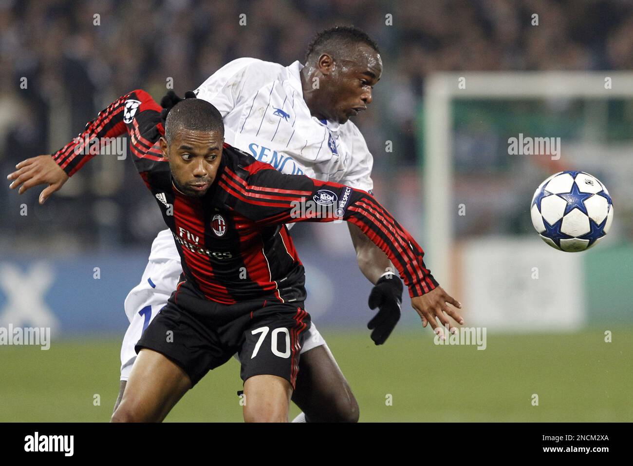 AC Milan's Rubinho, left, challenges for the ball with Auxerre's Dennis ...