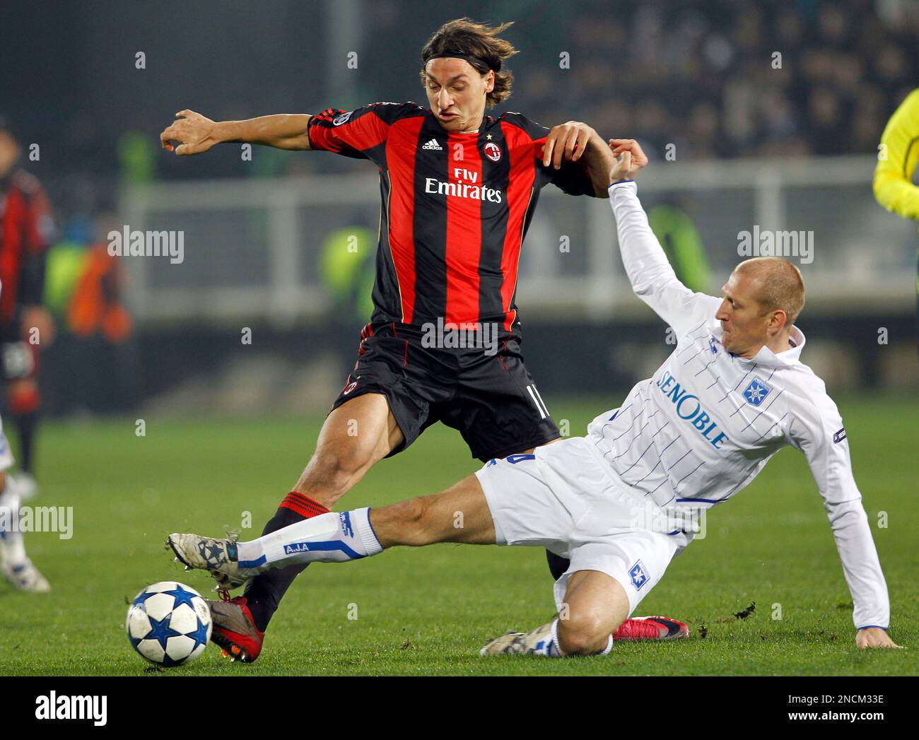 Auxerre's Stephane Grichting, right, challenges for the ball with AC ...