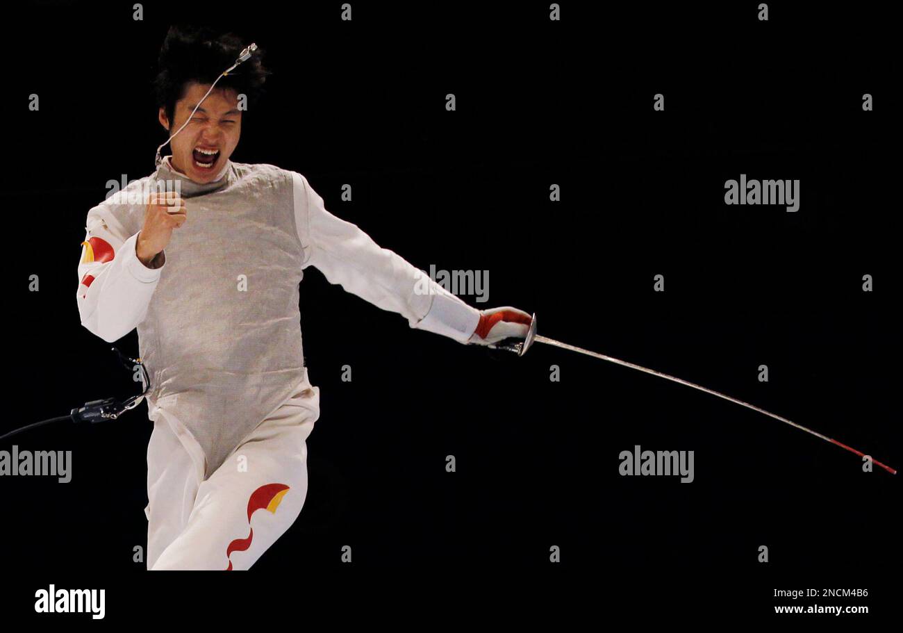 China's Lei Sheng celebrates after defeating Japan's Yuki Ota in the ...