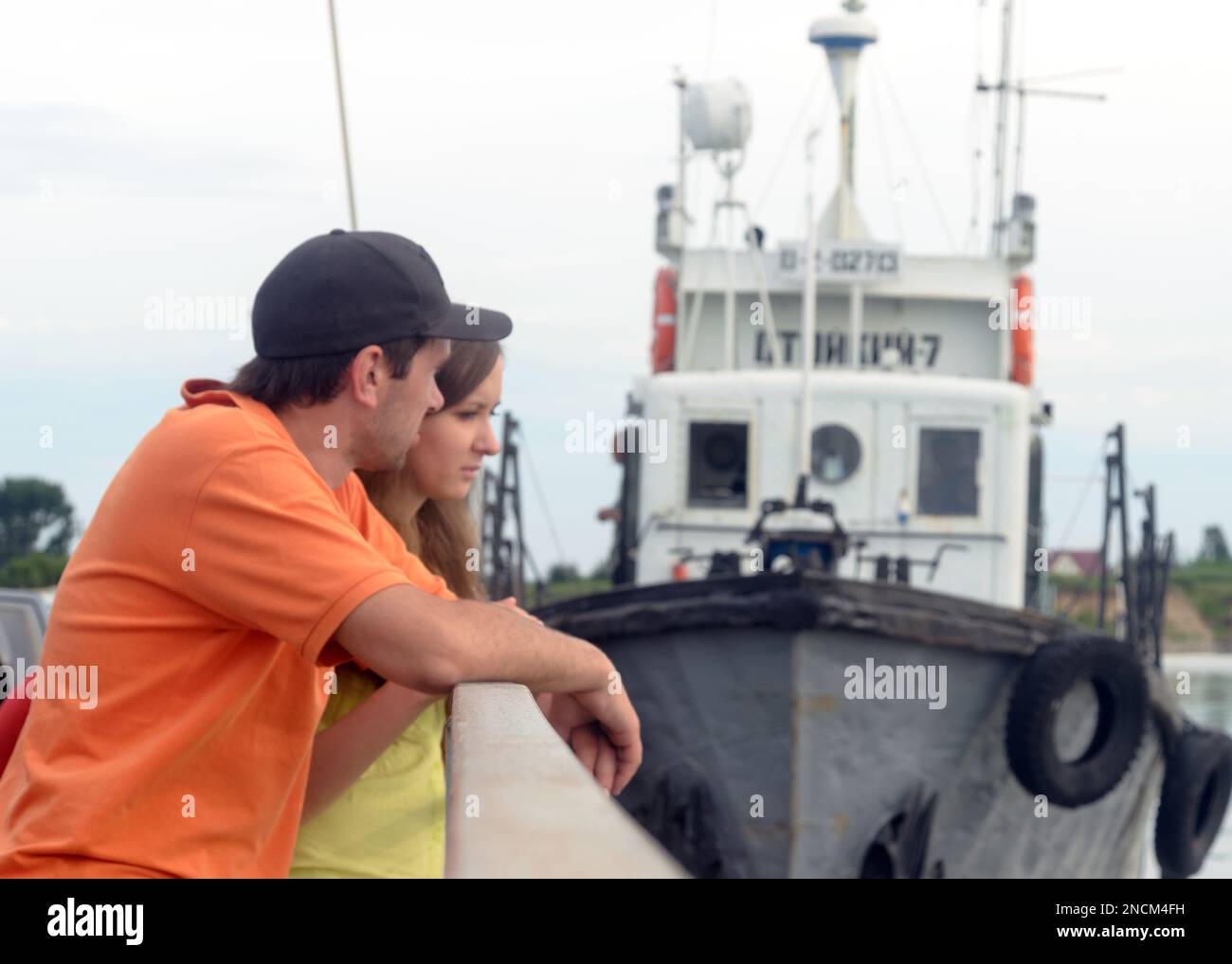 Couple man and woman standing pensively leaning on the railing of the ...