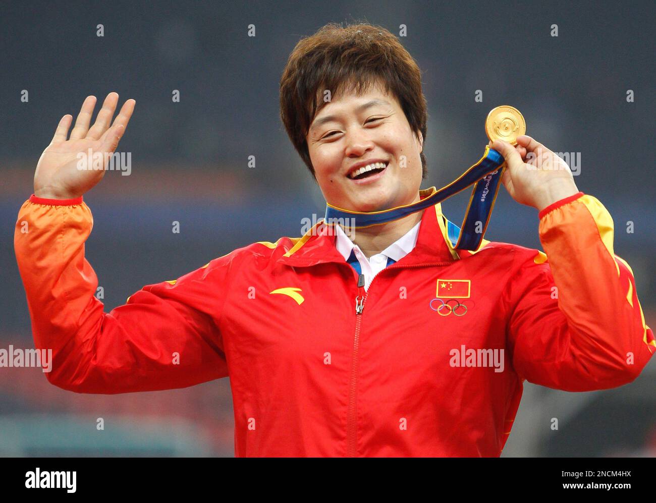 China's Li Yanfeng shows the gold medal she won in the women's discus ...