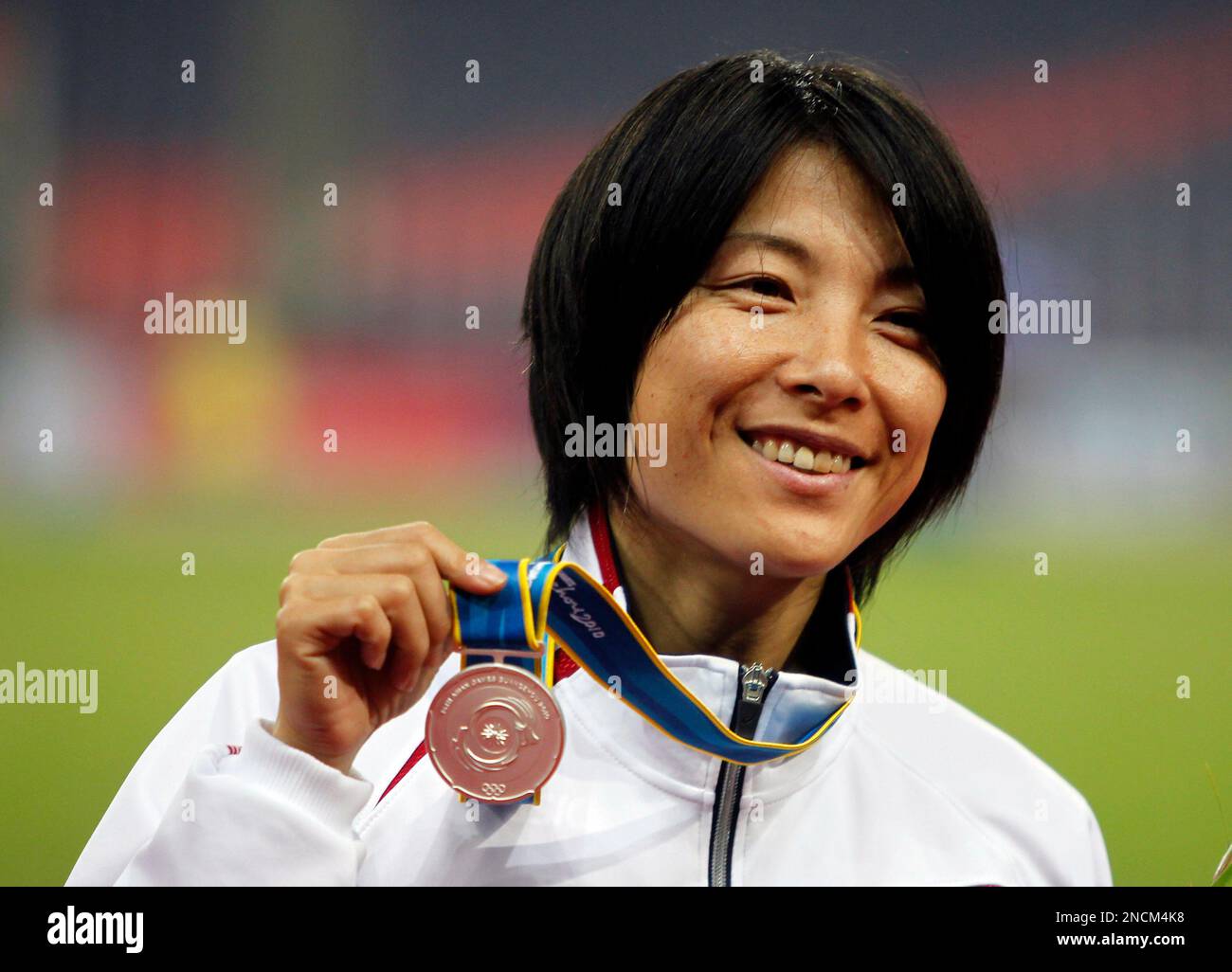 Japan's Yuki Nakata shows the silver medal she won in the women's heptathlon, at the 16th Asian ...
