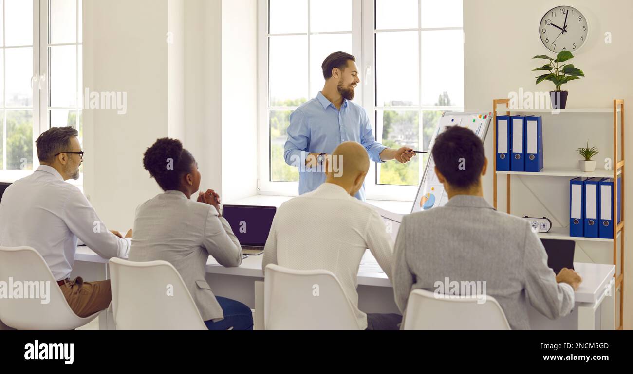 Male office worker is showing his management presentation with data ...