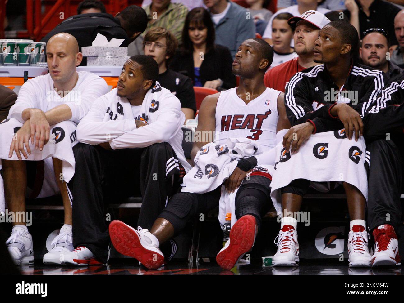 Miami Heat players look on from the bench during the first half of an ...