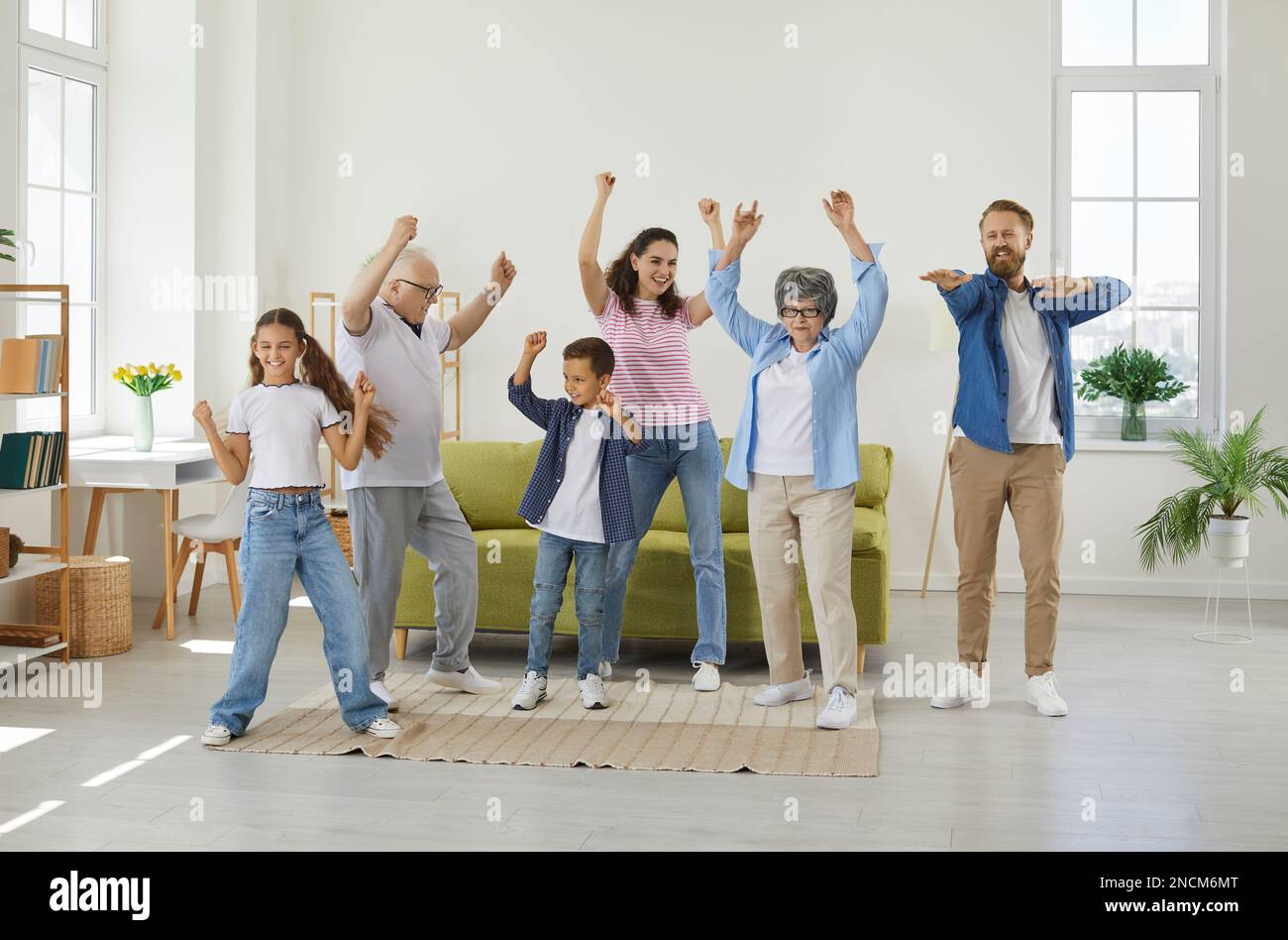 Joyful, funny, excited family having fun and dancing all together in ...