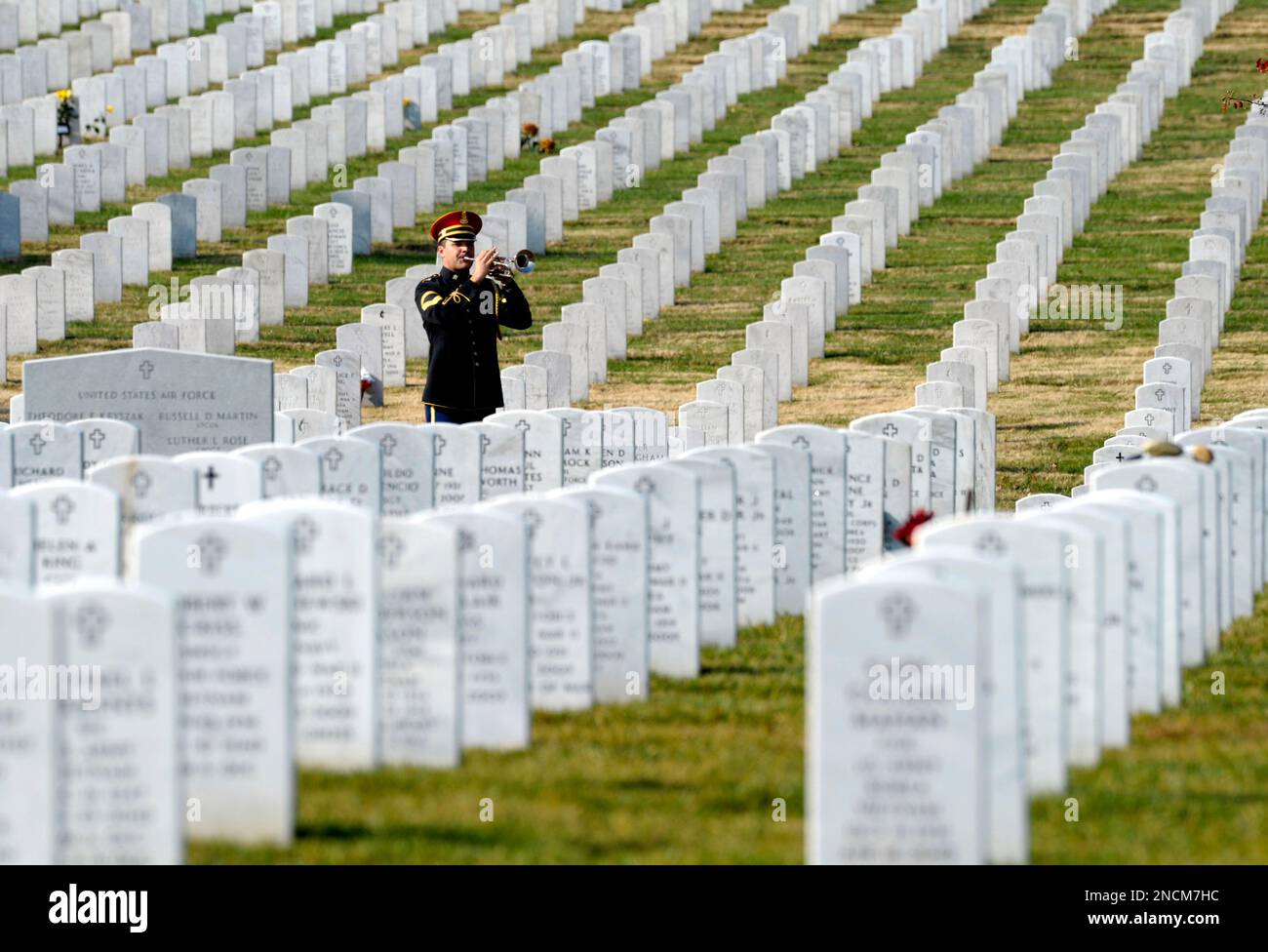 The bugler plays Taps during the burial service for Michael L ...