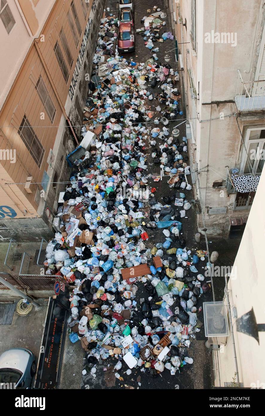 Uncollected trash are piled up on a street in Naples, Italy, Monday ...