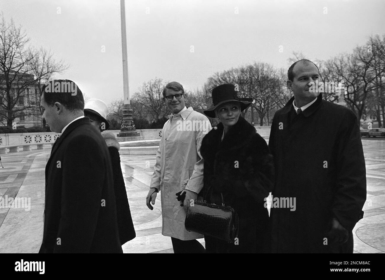 Dr. Samuel Sheppard, right, walks with his wife Ariane, and son, Samuel ...