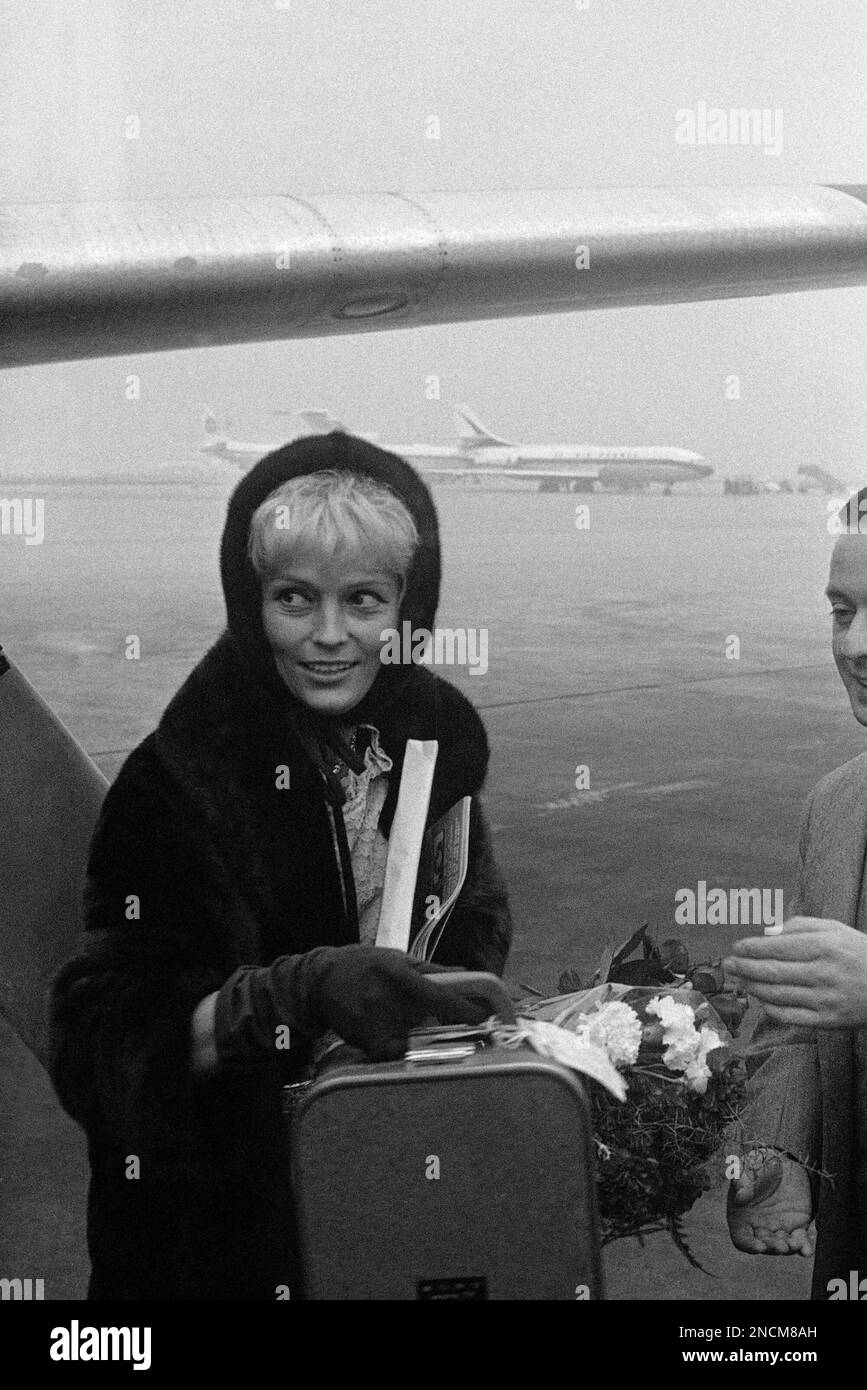 Mrs. Ariane Sheppard, wife of Dr. Sam Sheppard, prepares to board an ...
