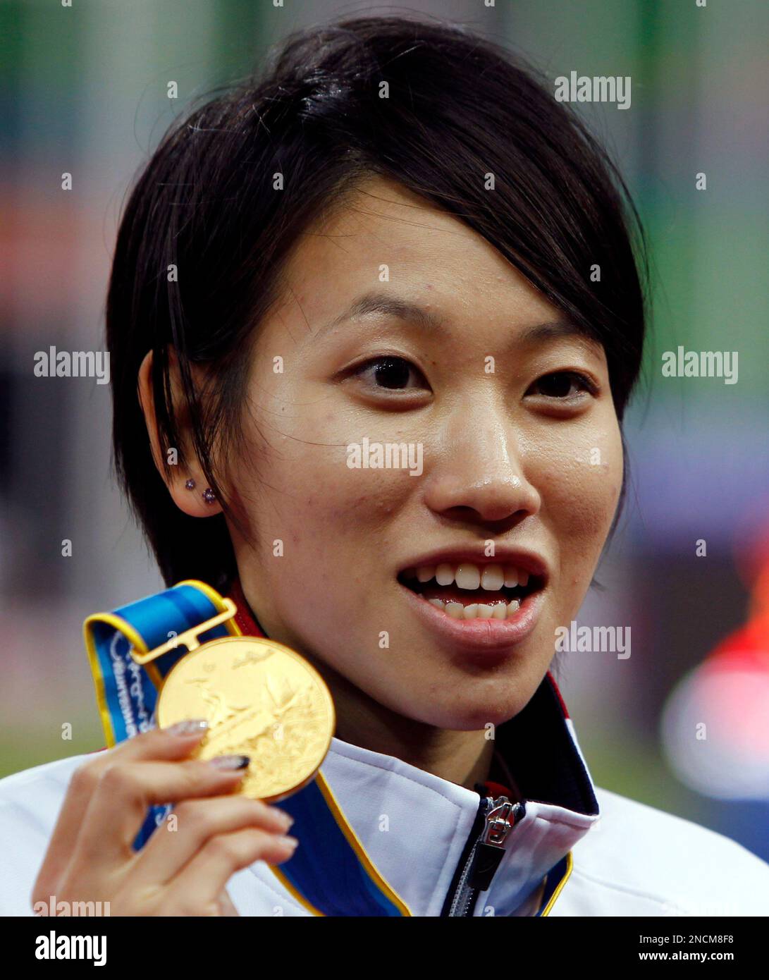 Japan's Chisato Fukushima shows the gold medal she won in the women's ...