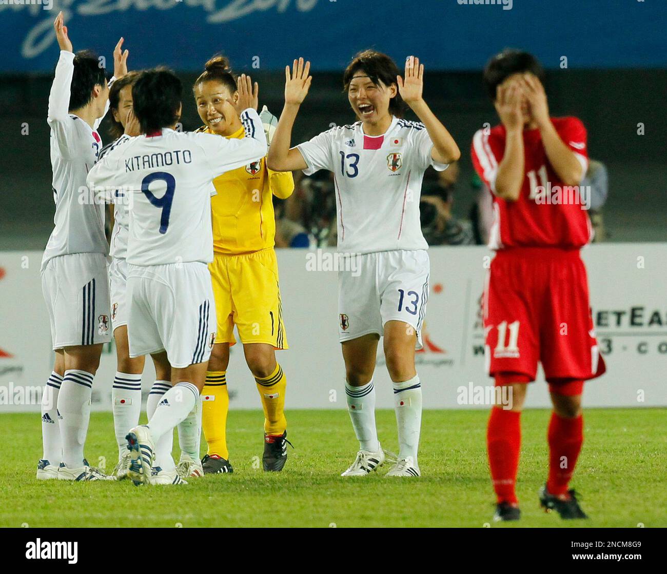 Japanese players celebrate after they defeated North Korea in the women ...