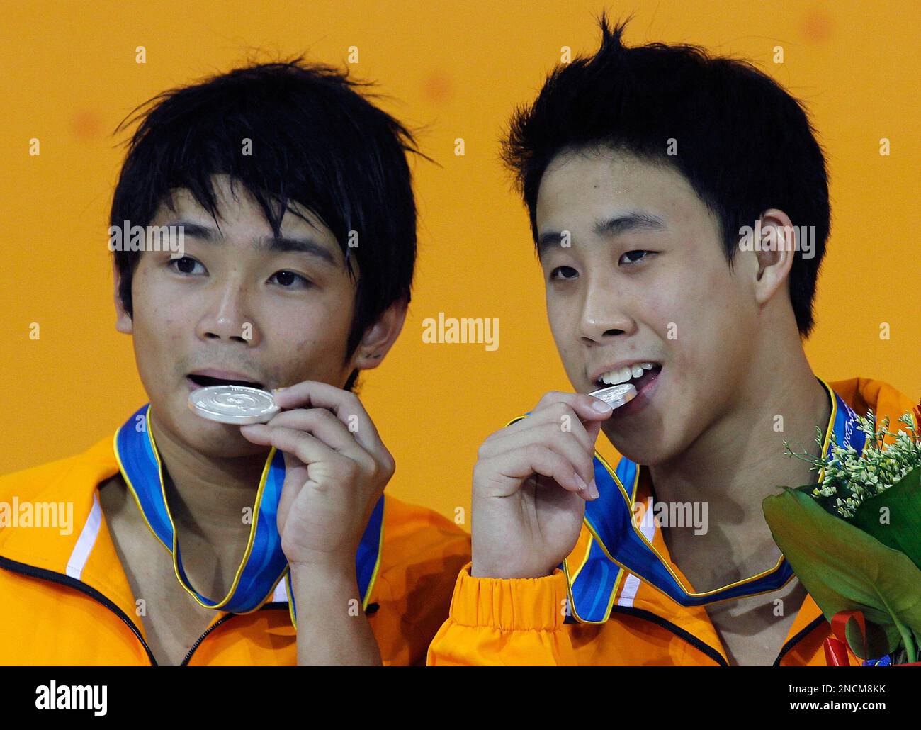 Malaysia's Bryan Lomas, left and Tze Liang Ooi pose with their silver ...