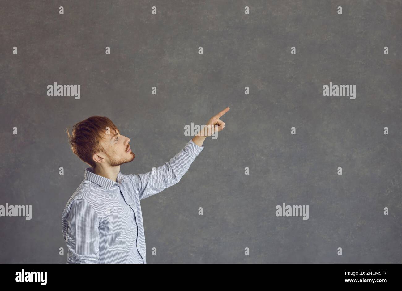 Side profile photo of handsome man with copyspace index finger right in ...