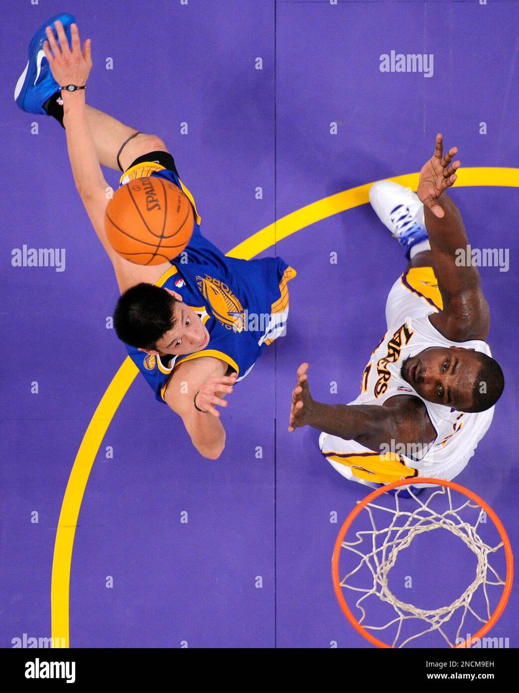 Golden State Warriors point guard Jeremy Lin, left, puts up a shot as ...