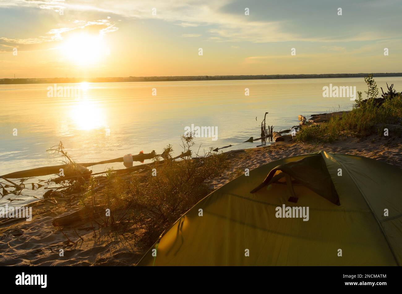 Top tourist tents, standing on the sandy shore of the beach trees, on ...