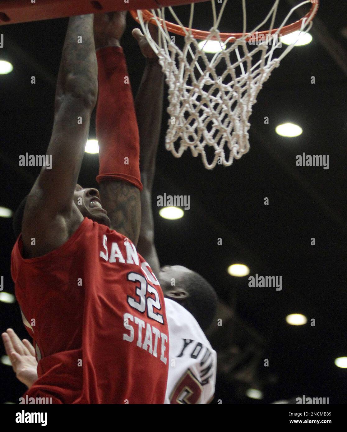 San Diego State forward Billy White (32) dunks the ball over IUPUI ...