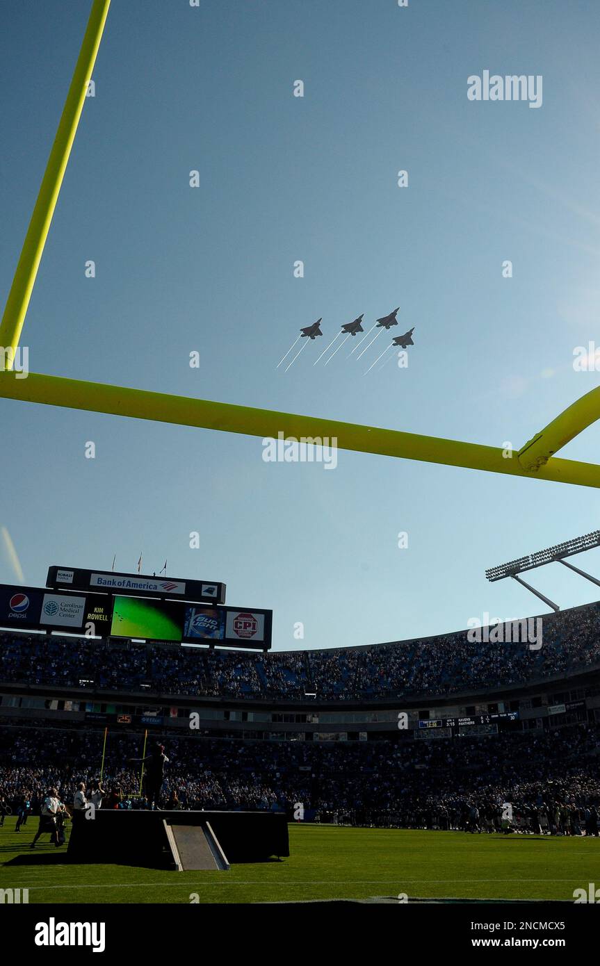An F-22 fighter squadron does a flyover prior to the start of an NFL ...