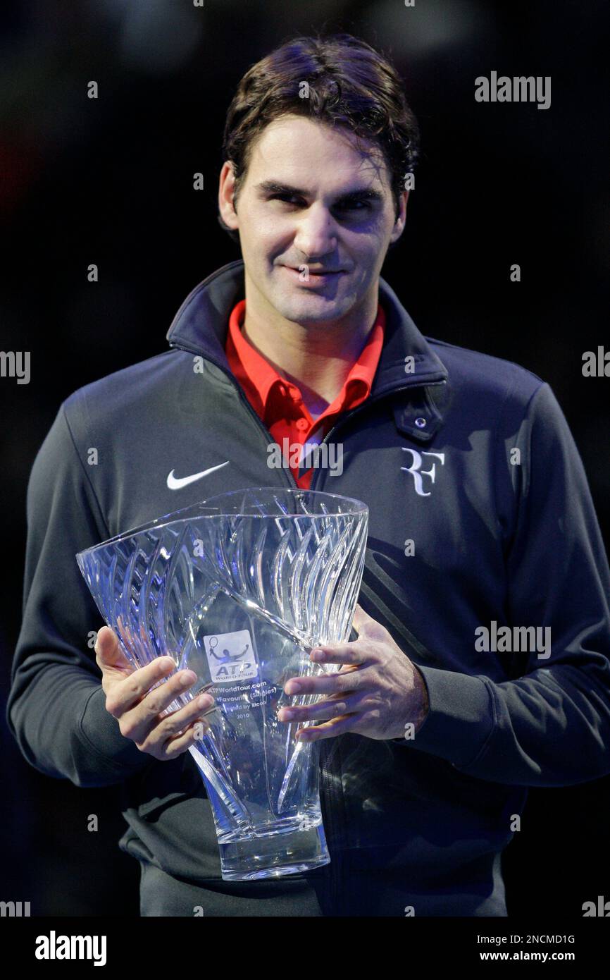 Switzerland's Roger Federer poses with the Fans' Favourite Award trophy ...