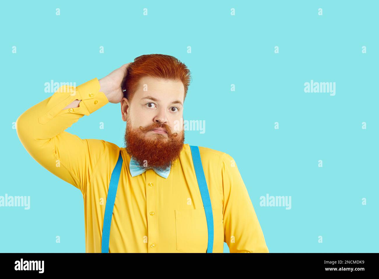 Fat man isolated on turquoise background scratches head with funny ...