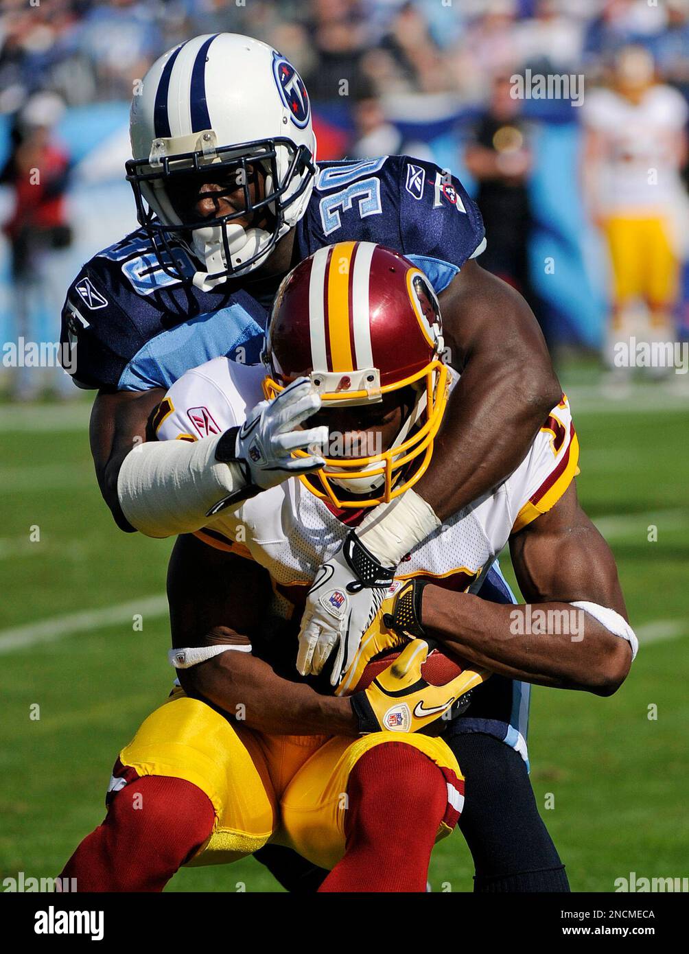 Tennessee Titans cornerback Jason McCourty, top, wraps up Washington ...