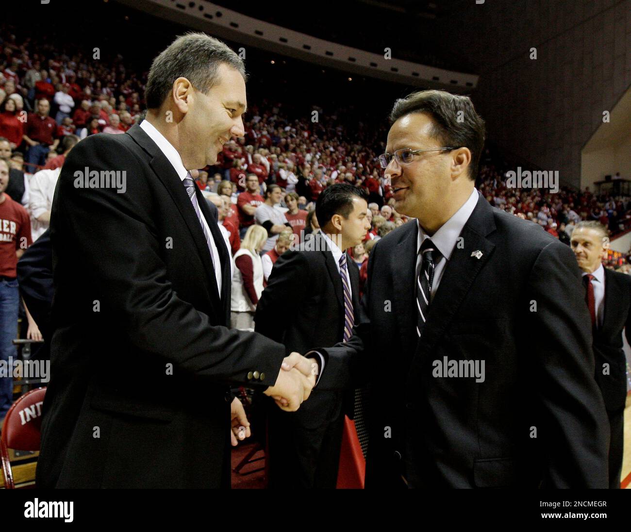 Evansville head coach Marty Simmons, left, is greeted by Indiana head ...