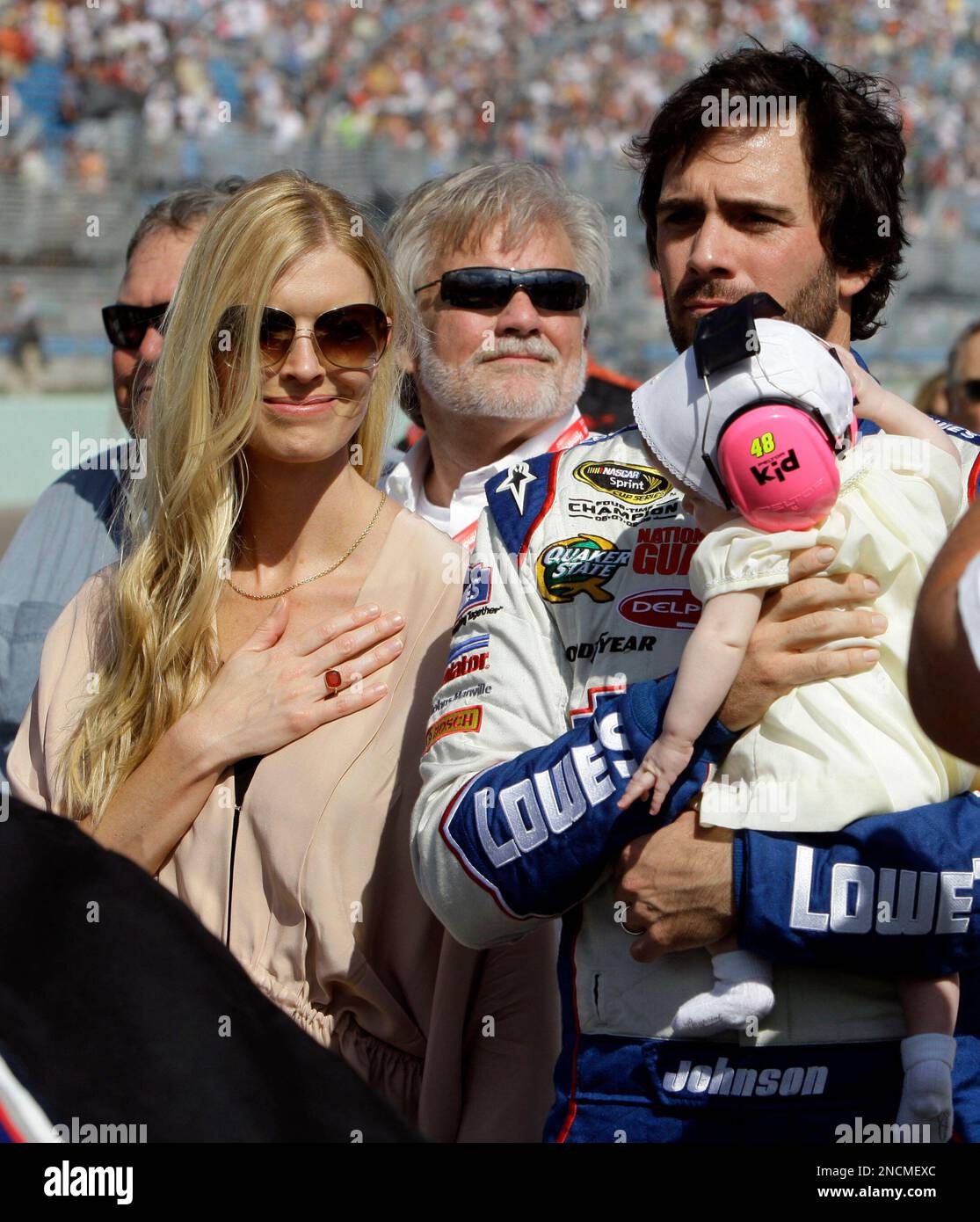 NASCAR driver Jimmie Johnson, right, holds his four-month-old daughter ...