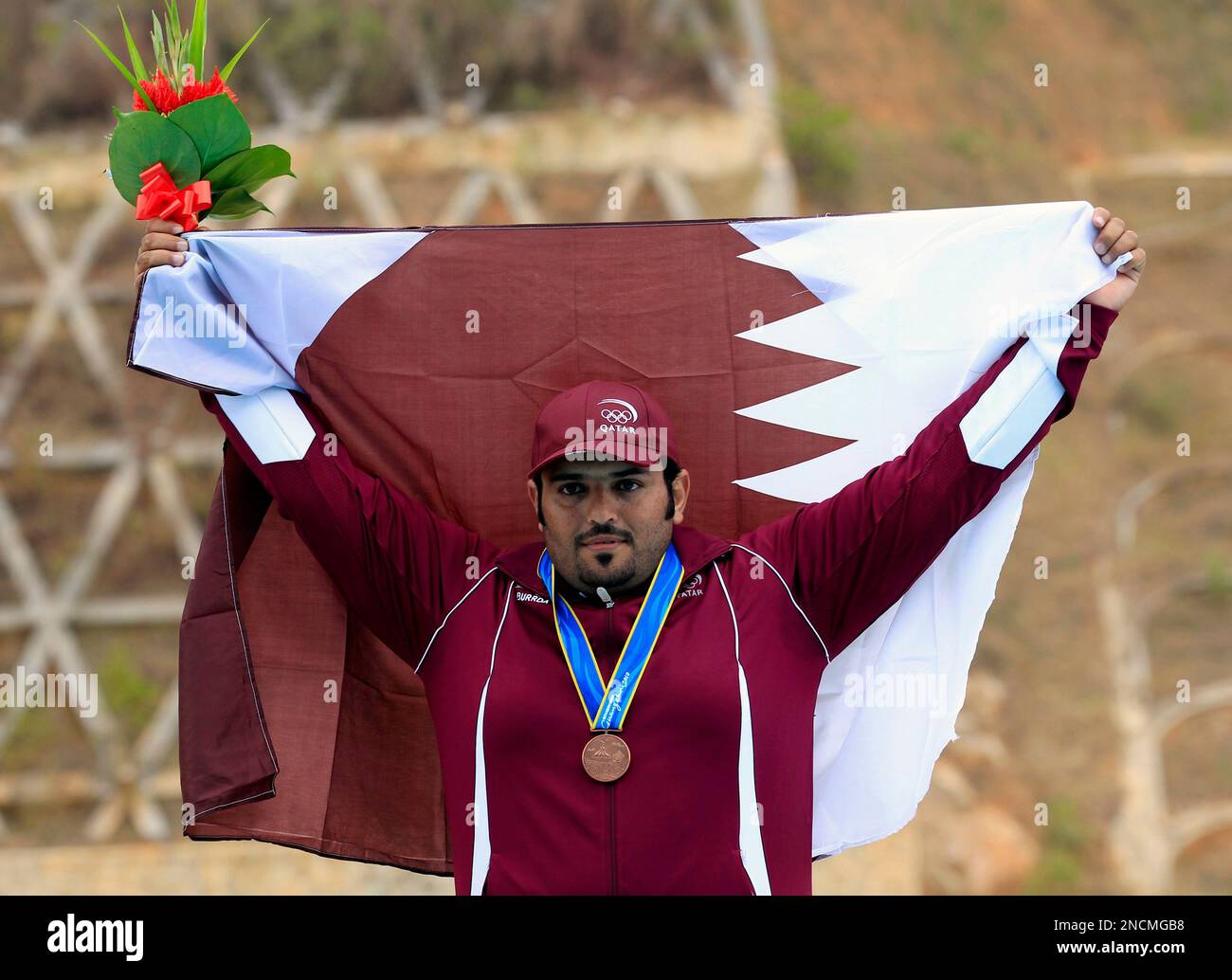 Qatar's Hamad Ali al Marri waves from the podium after receiving his ...