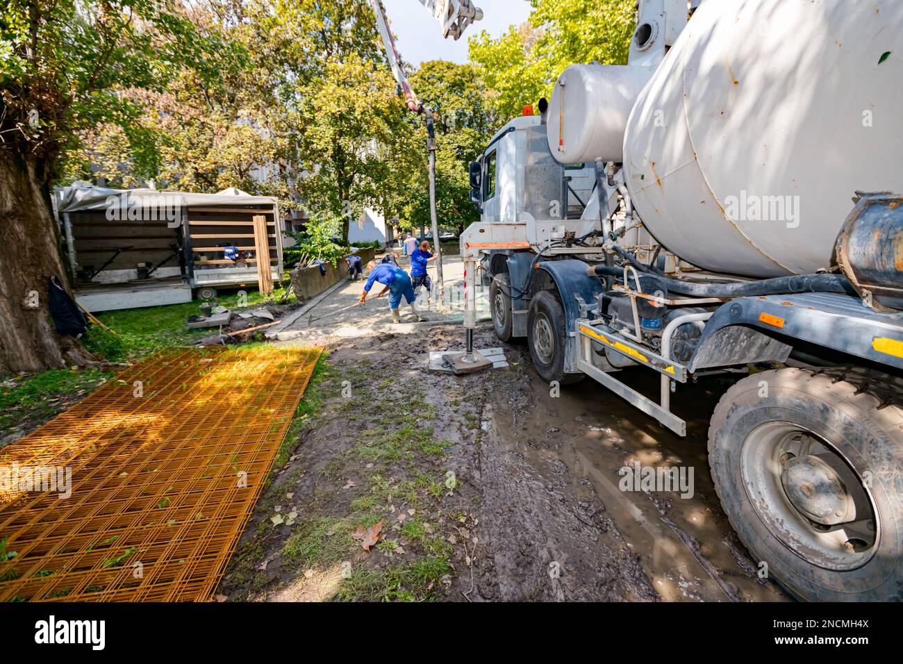 Pouring fresh concrete from mixer truck, Construction worker is ...
