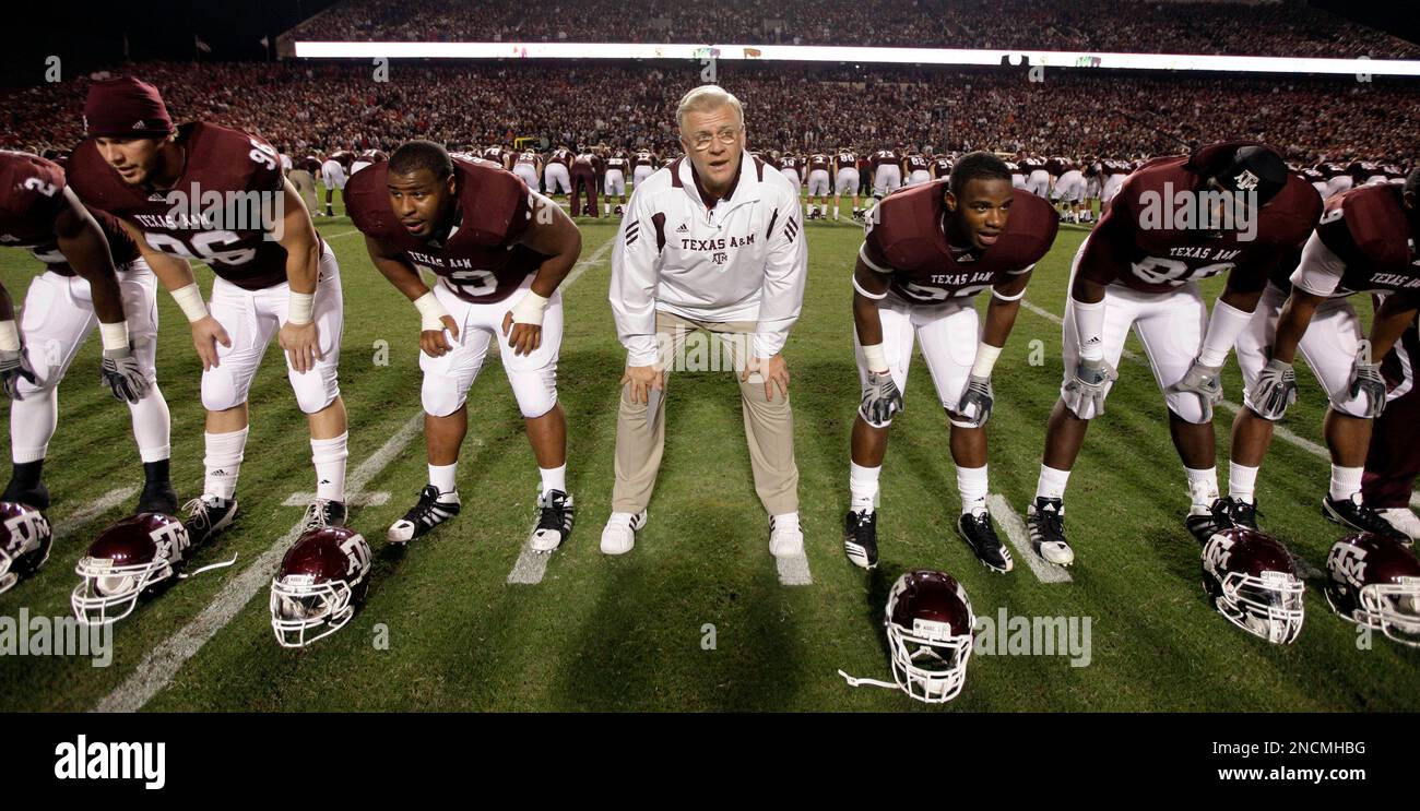 Texas A&M coach Mike Sherman, center, joins players as they sing the ...