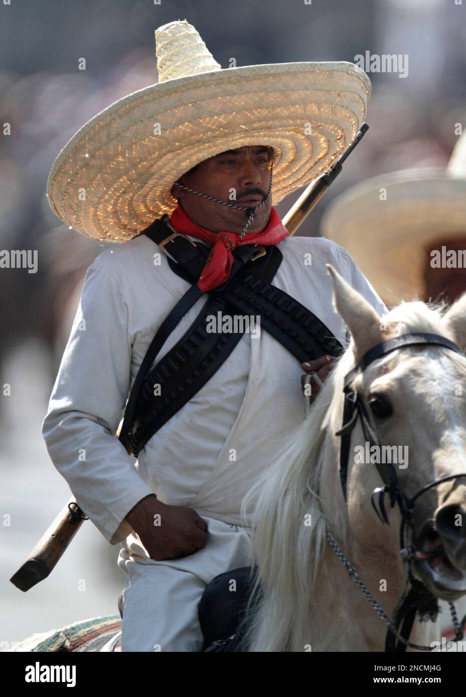 A man dressed as a Mexican Revolutionary fighter attends a parade ...