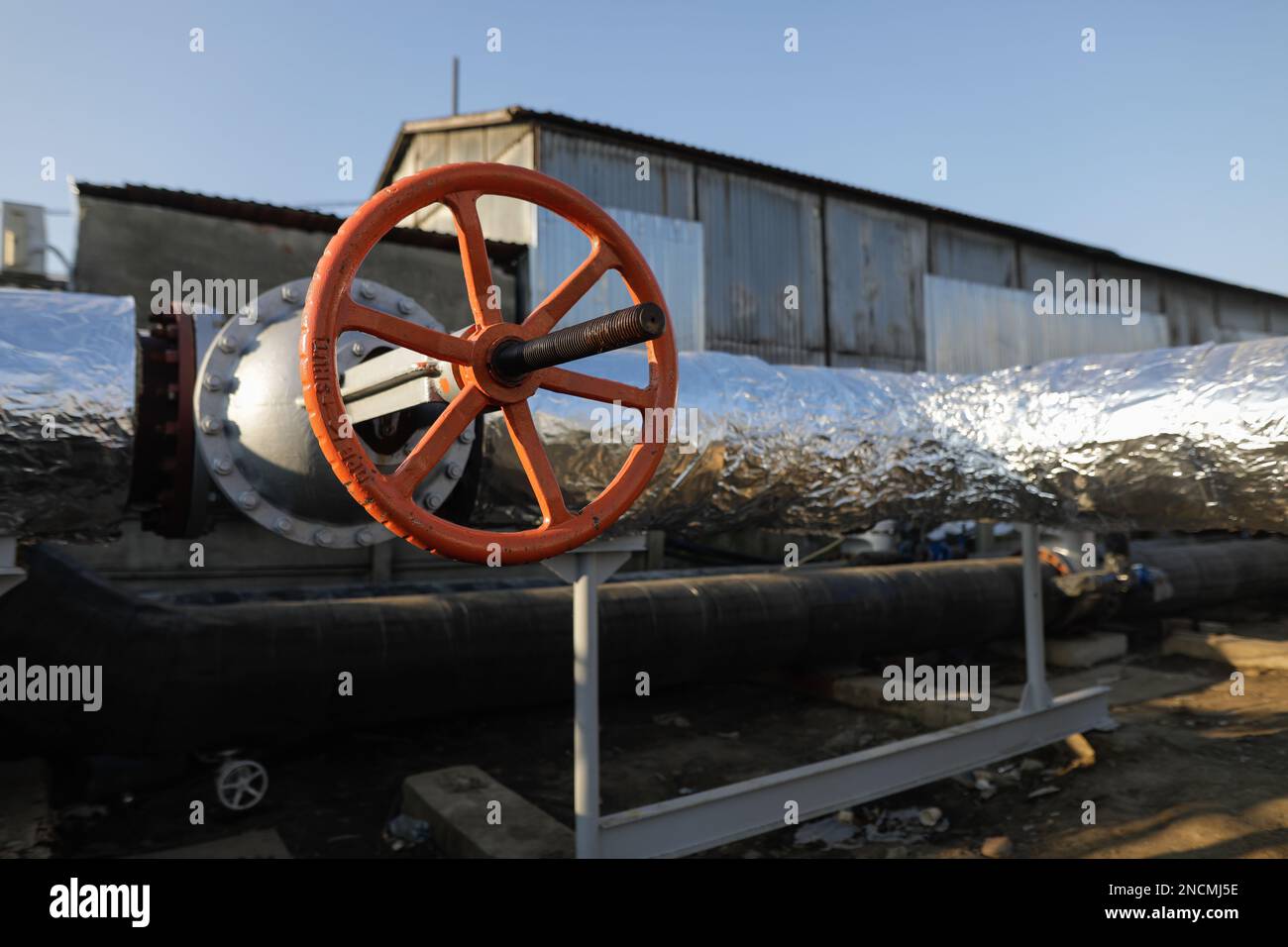 Shallow depth of field details with a metallic pipe valve used to open ...