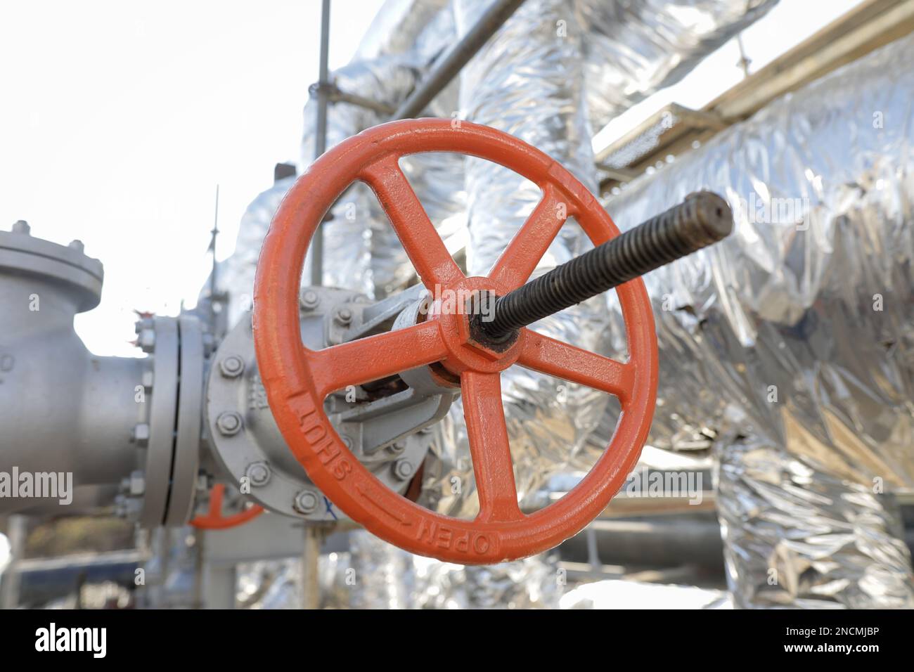 Shallow depth of field details with a metallic pipe valve used to open ...