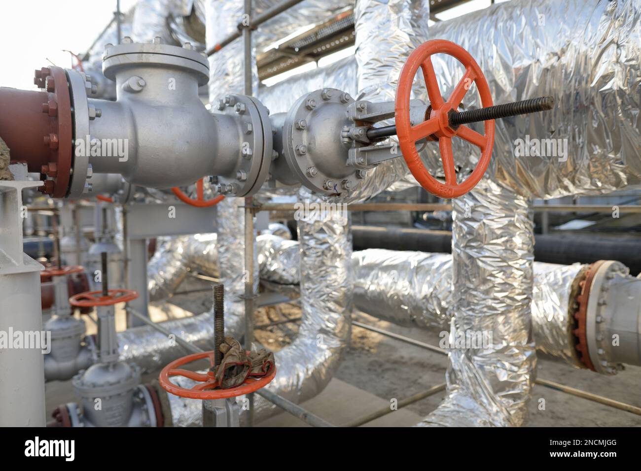 Shallow depth of field details with a metallic pipe valve used to open ...
