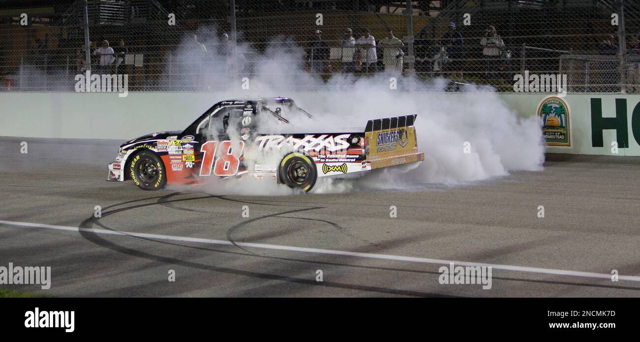 Kyle Busch celebrates after winning the the Ford 200 truck race in ...