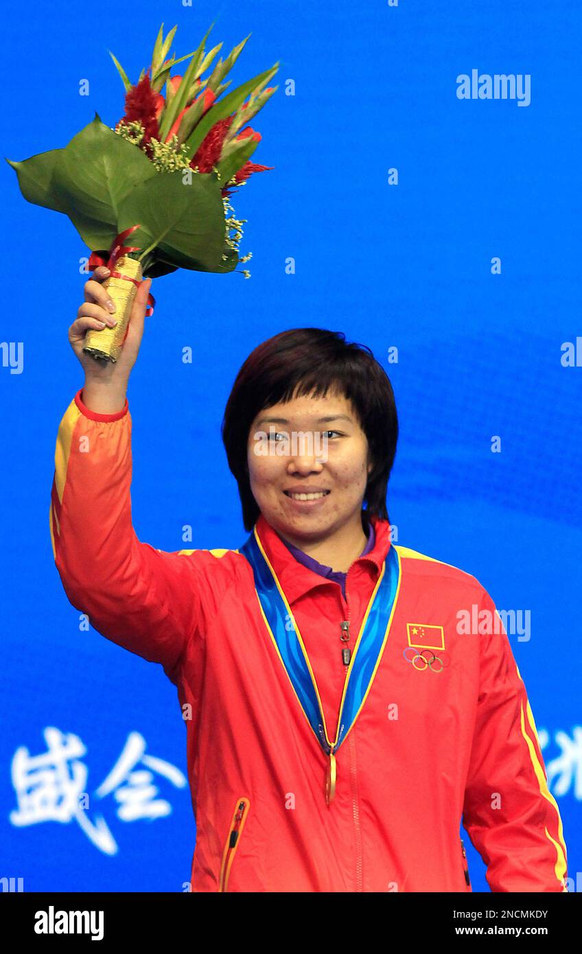 China's Li Xiaoxia celebrates during the award ceremony of the women's ...