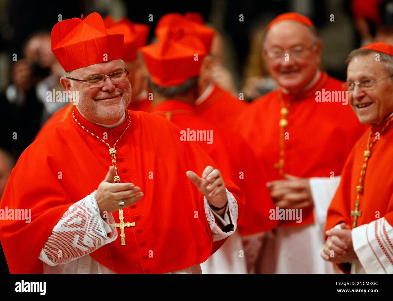 Newly-appointed German Cardinal Reinhard Marx, left, is congratulated ...