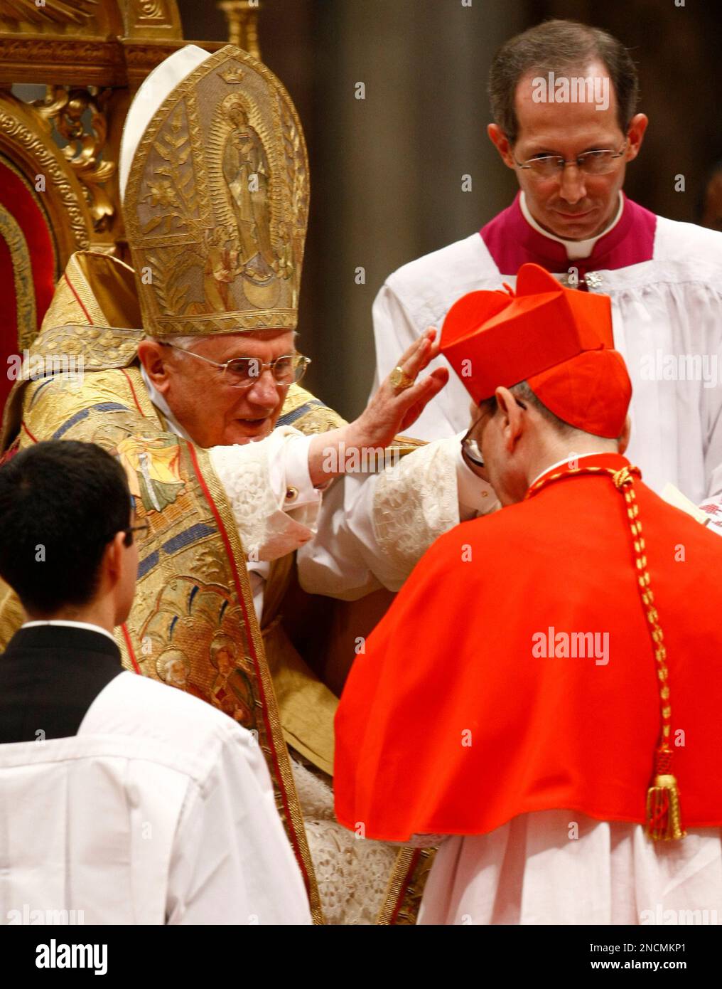 Newly-elevated Cardinal Angelo Amato, right, receives the red three ...
