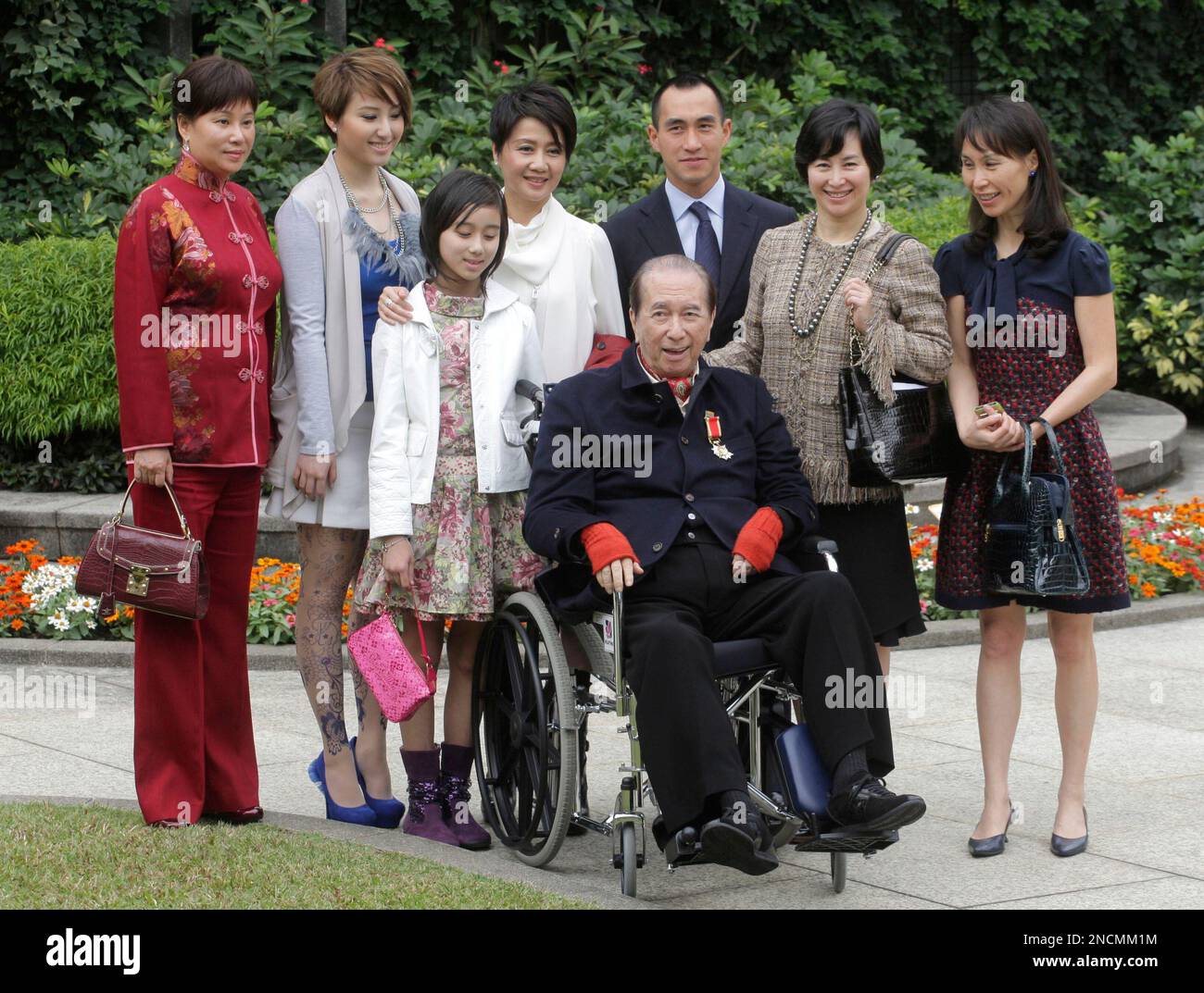 Hong Kong and Macau tycoon Stanley Ho, center, poses with his family ...