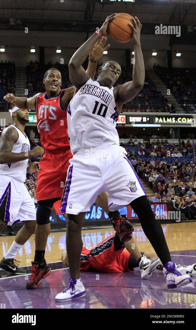 Sacramento Kings center Samuel Dalembert, right, grabs a rebound ...