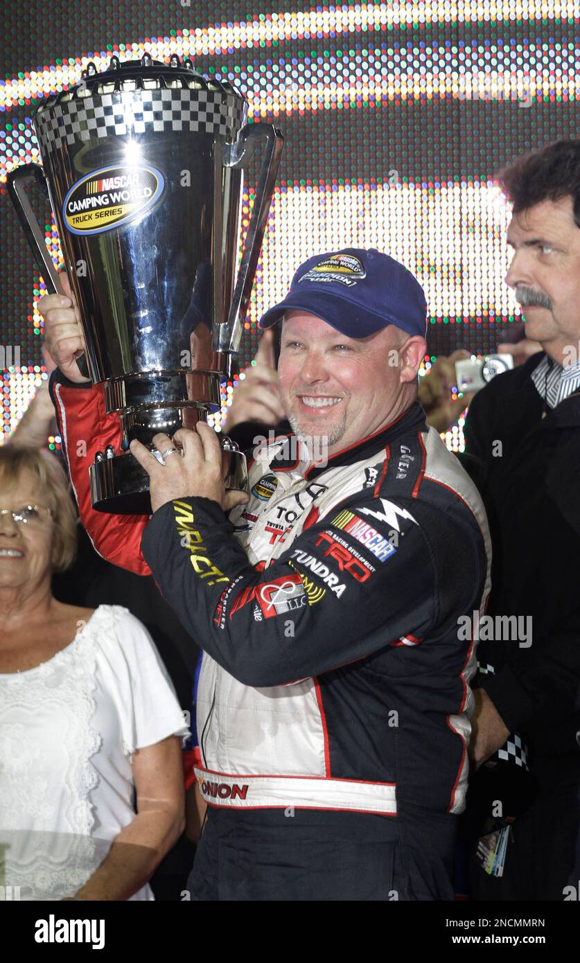 Todd Bodine displays the trophy he won for winning the Camping World ...