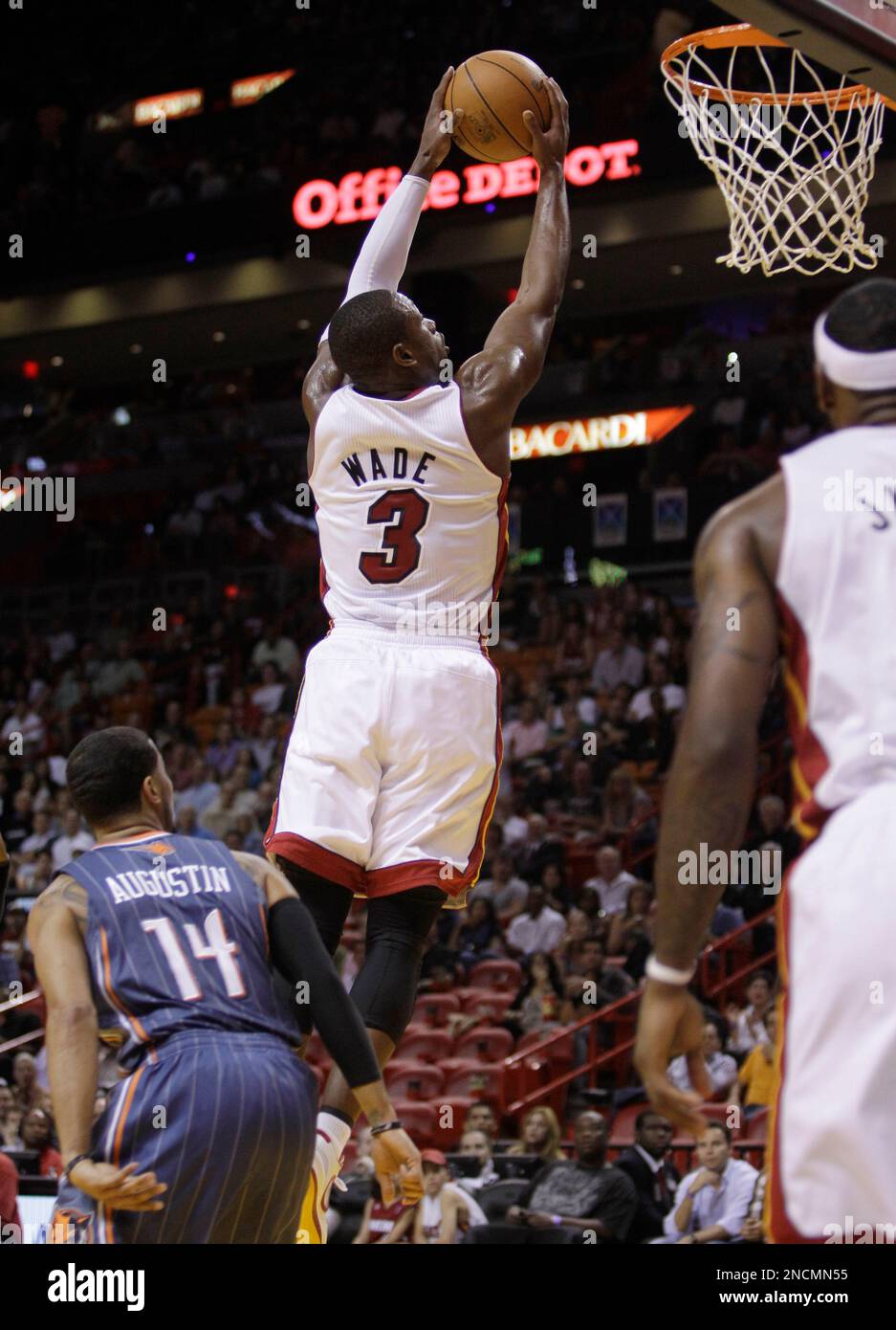 Miami Heat guard Dwyane Wade (3) shoots as Charlotte Bobcats guard D.J ...