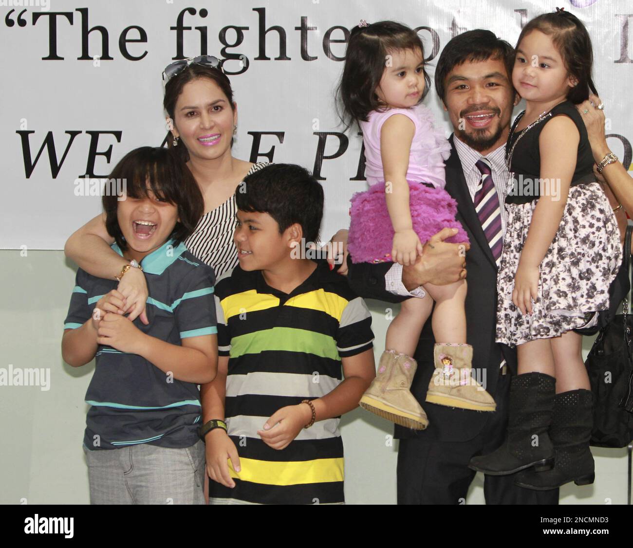 Filipino boxing champion Manny Pacquiao holds his daughters Princess ...